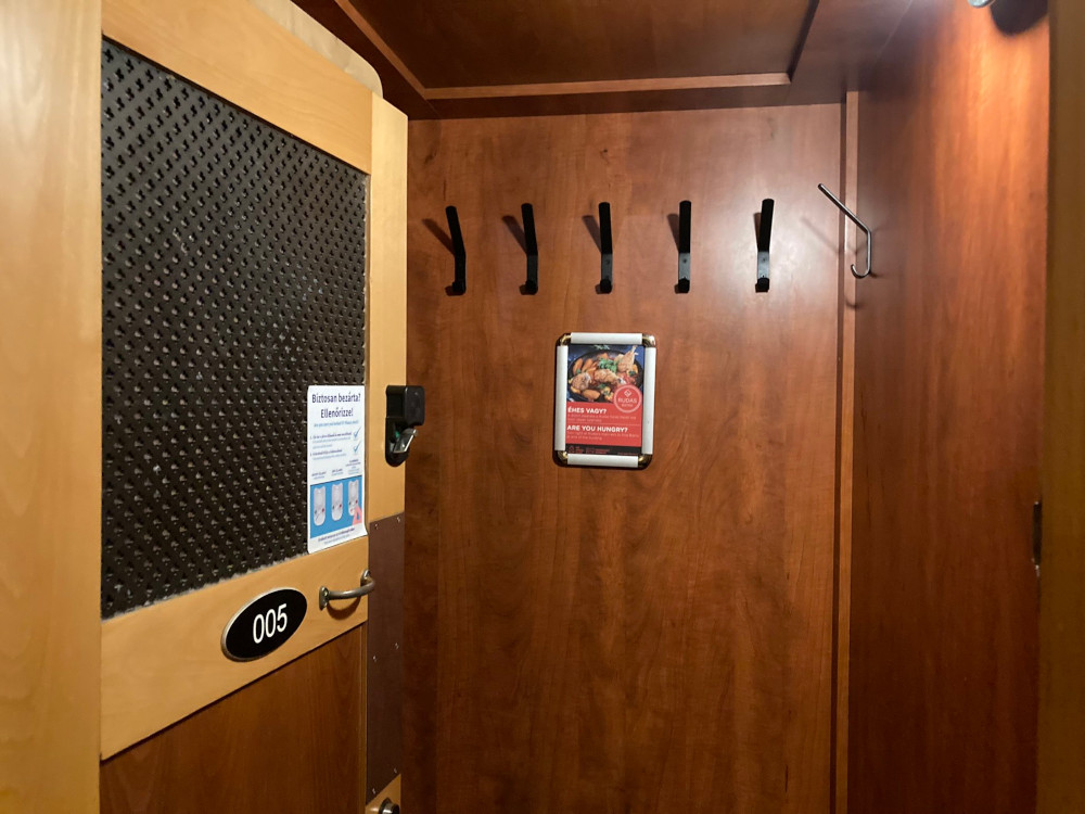 A dark wooden changing cabin, a small changing cubicle with a lock on ...