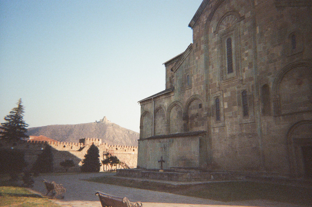 The side of Svetitskhoveli Cathedral with Jvari Monastery on the ...