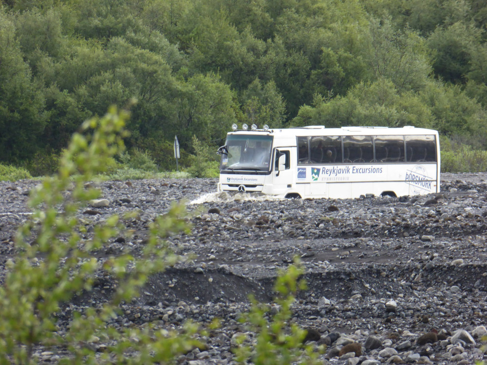 A tour bus with slightly higher suspension than usual, up to its nose ...
